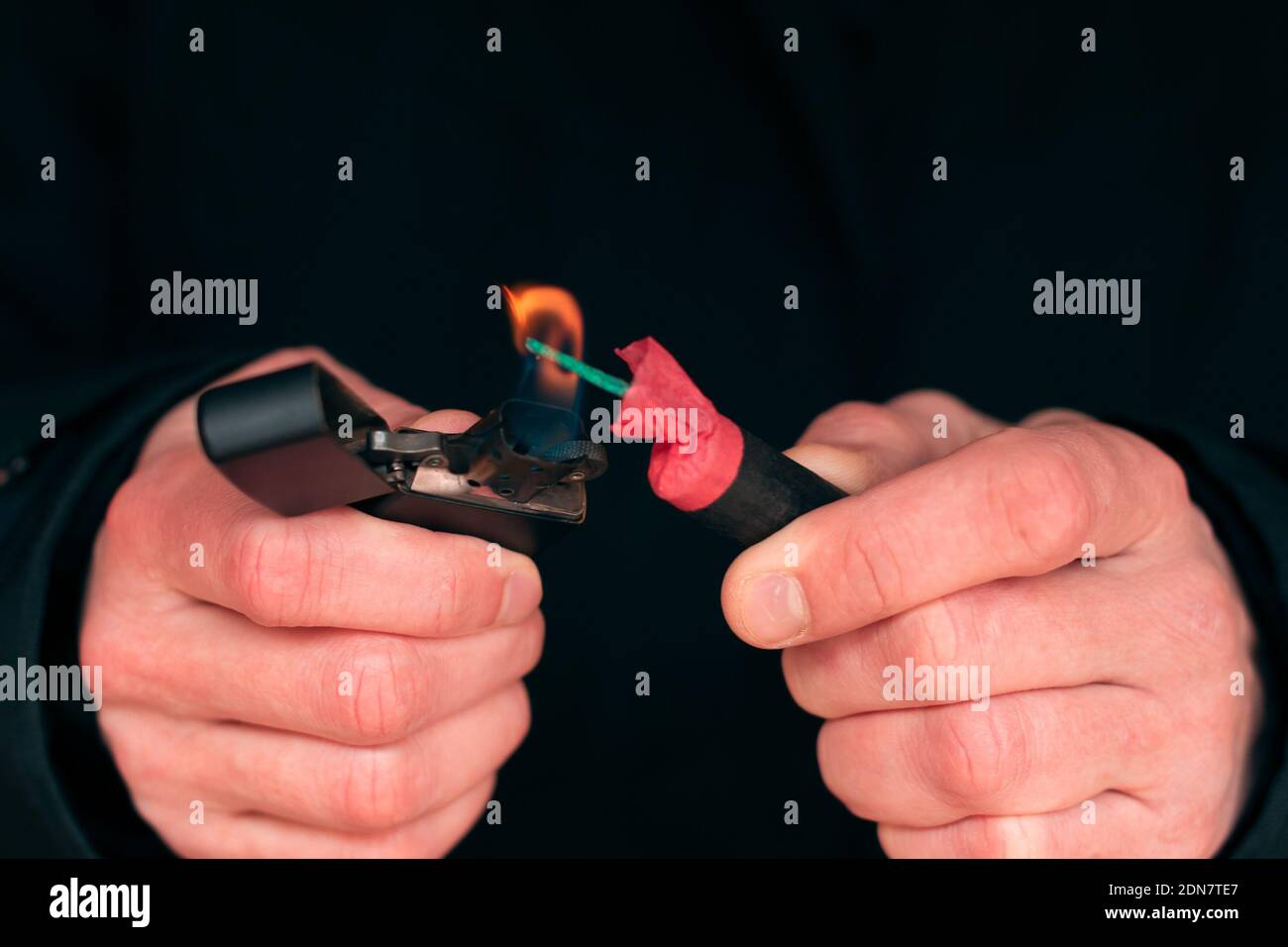 Setting Fire to the Firecracker. Man in Black Clothes Lighting Up the ...