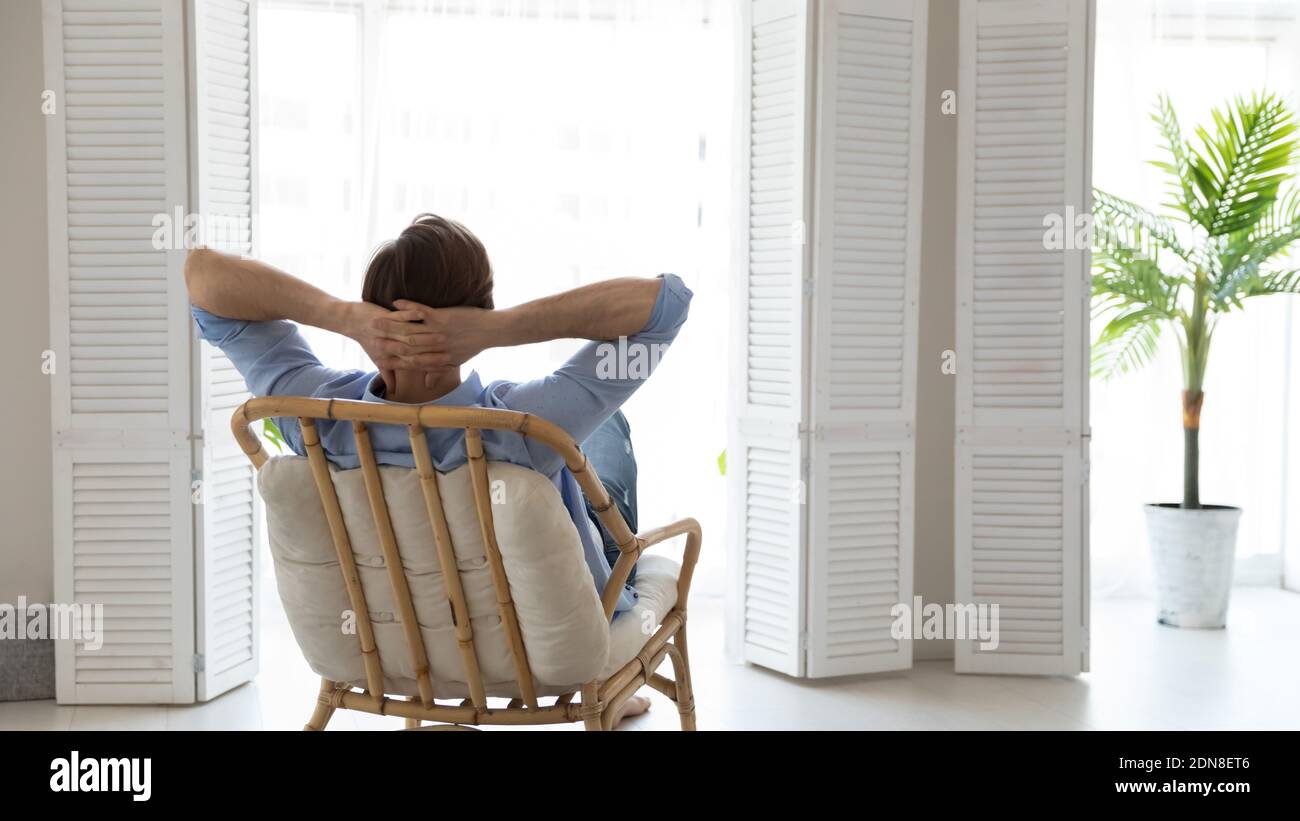 Back rear view young caucasian man relaxing on comfortable chair Stock ...