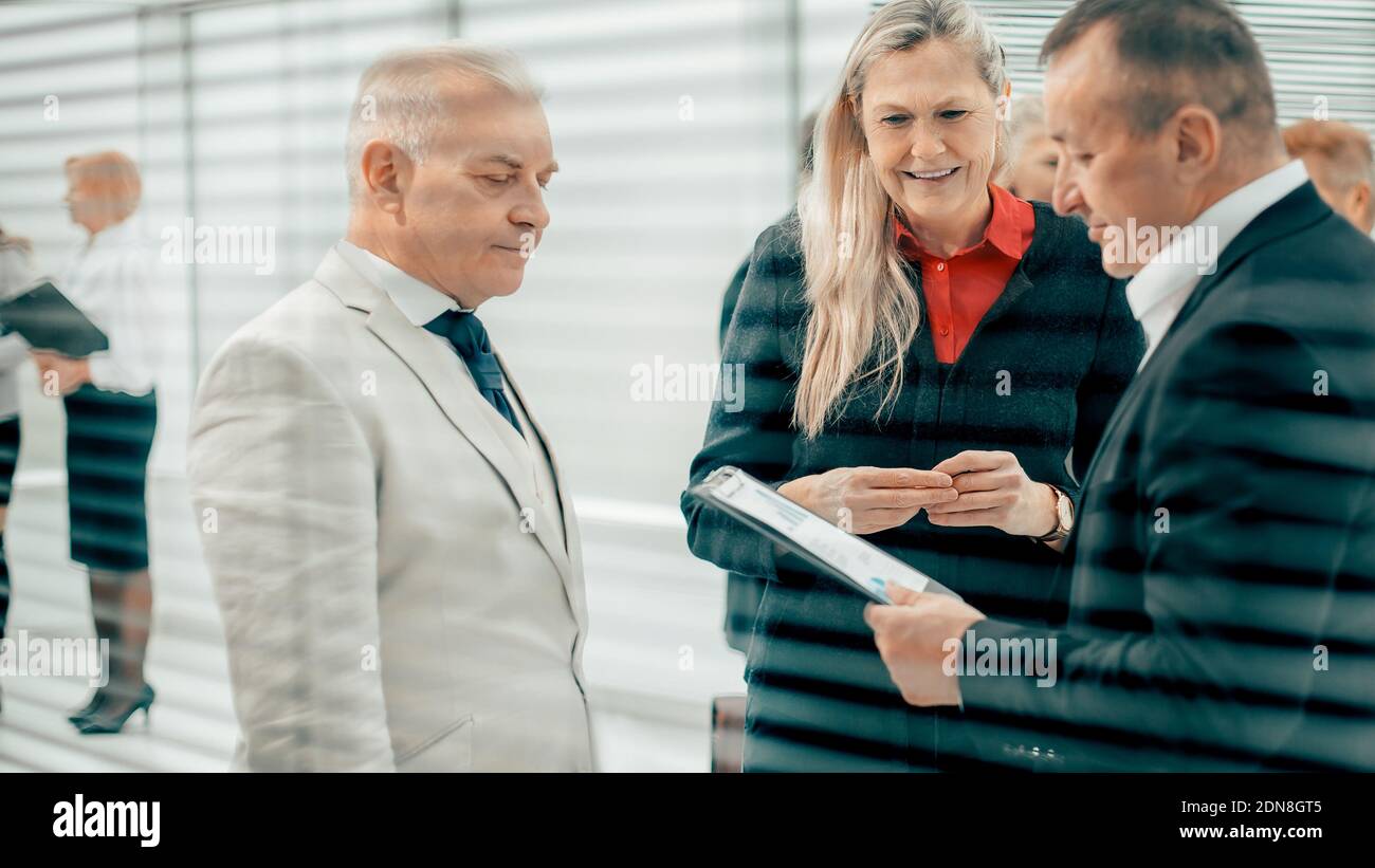 through the blinds. project Manager reading business document Stock ...
