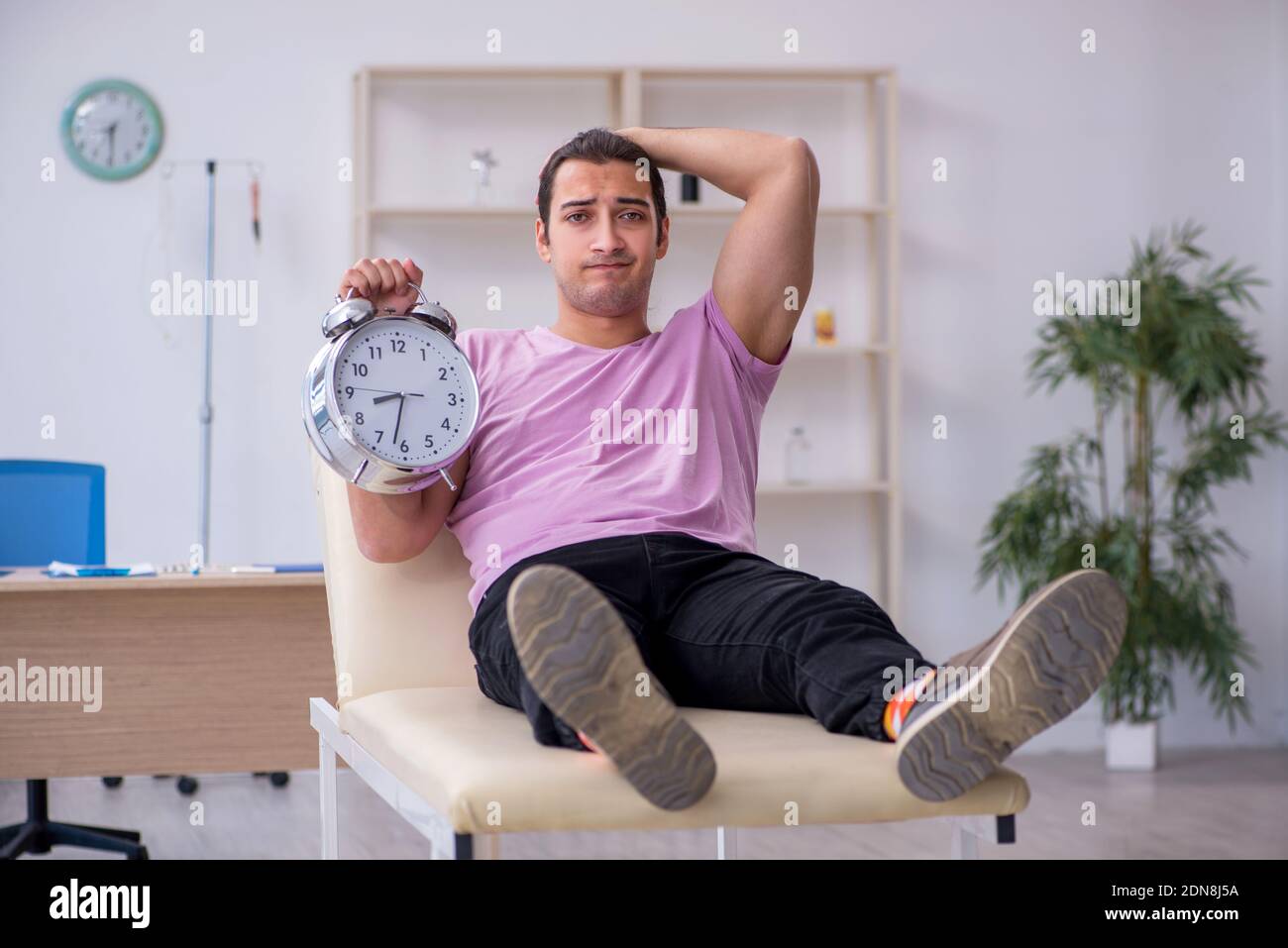 Male patient waiting for doctor in time management concept Stock Photo ...