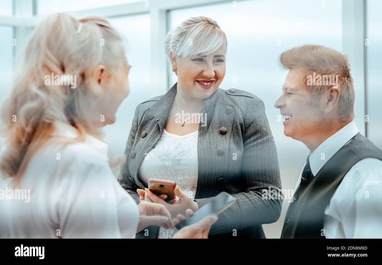 close up. smiling employees standing in the office lobby Stock Photo ...