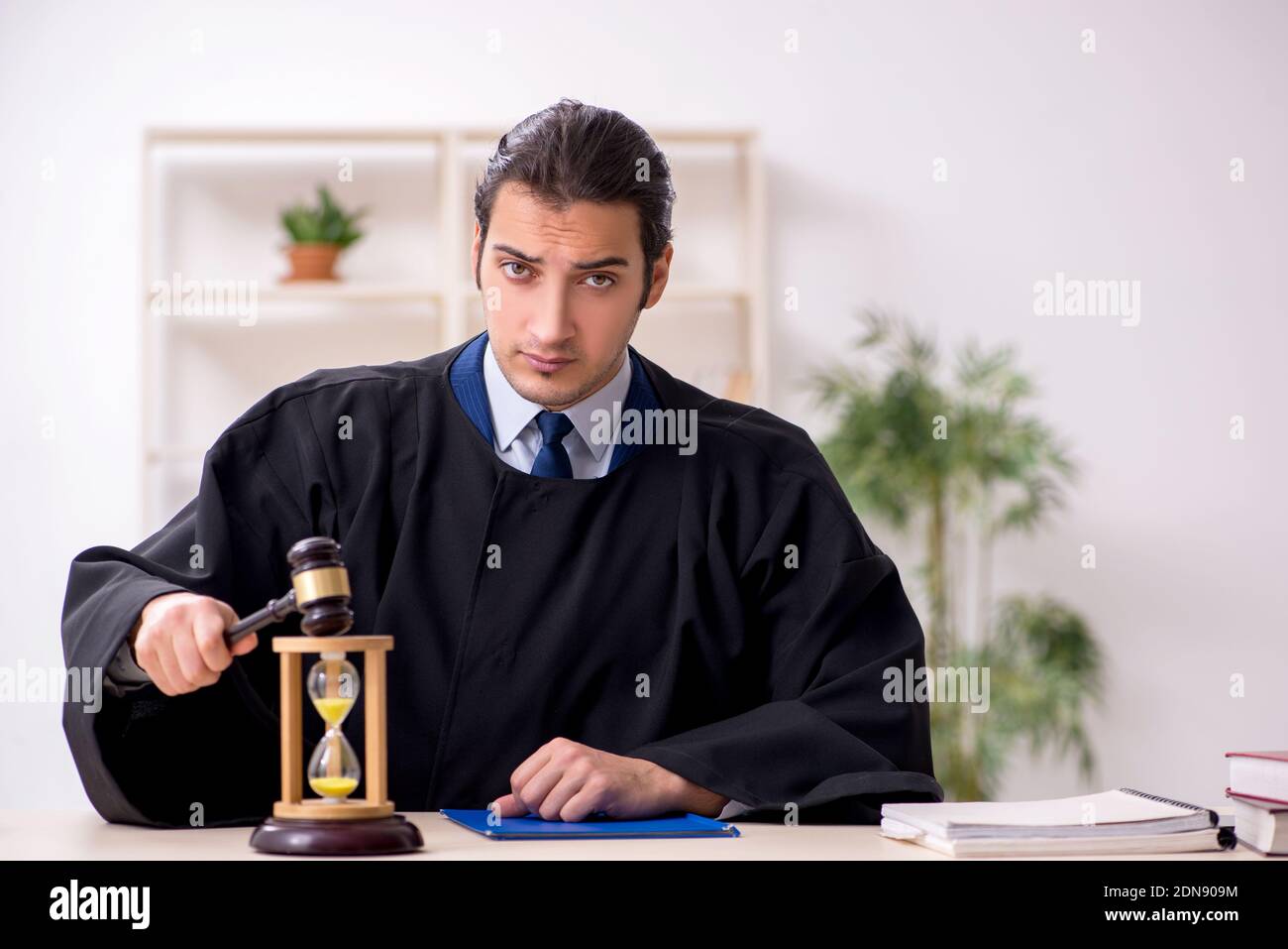 Young judge in time management concept Stock Photo - Alamy
