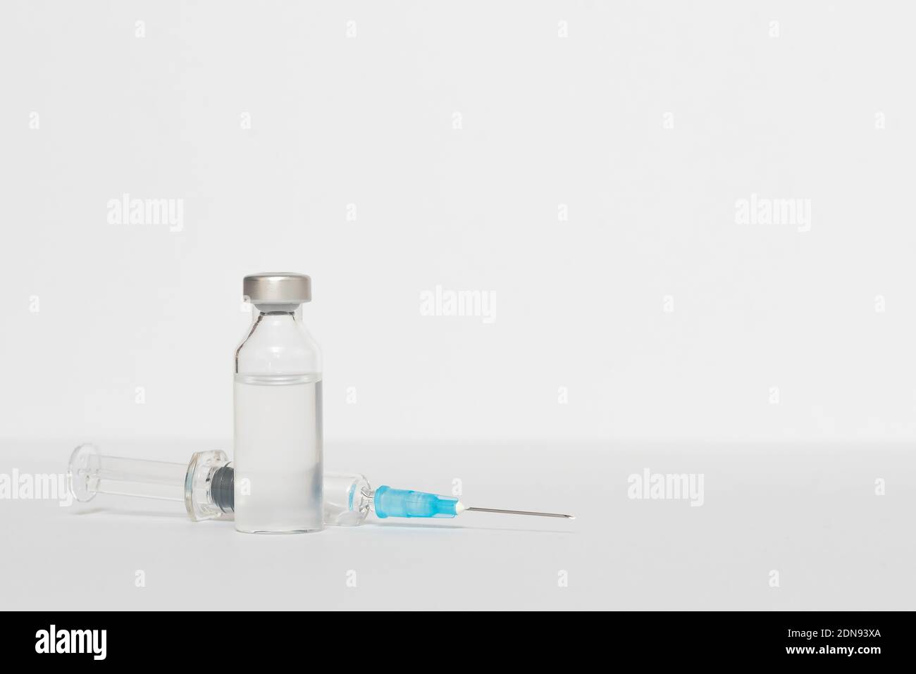 Syringe with a needle placed in a horizontal position and just in front ...