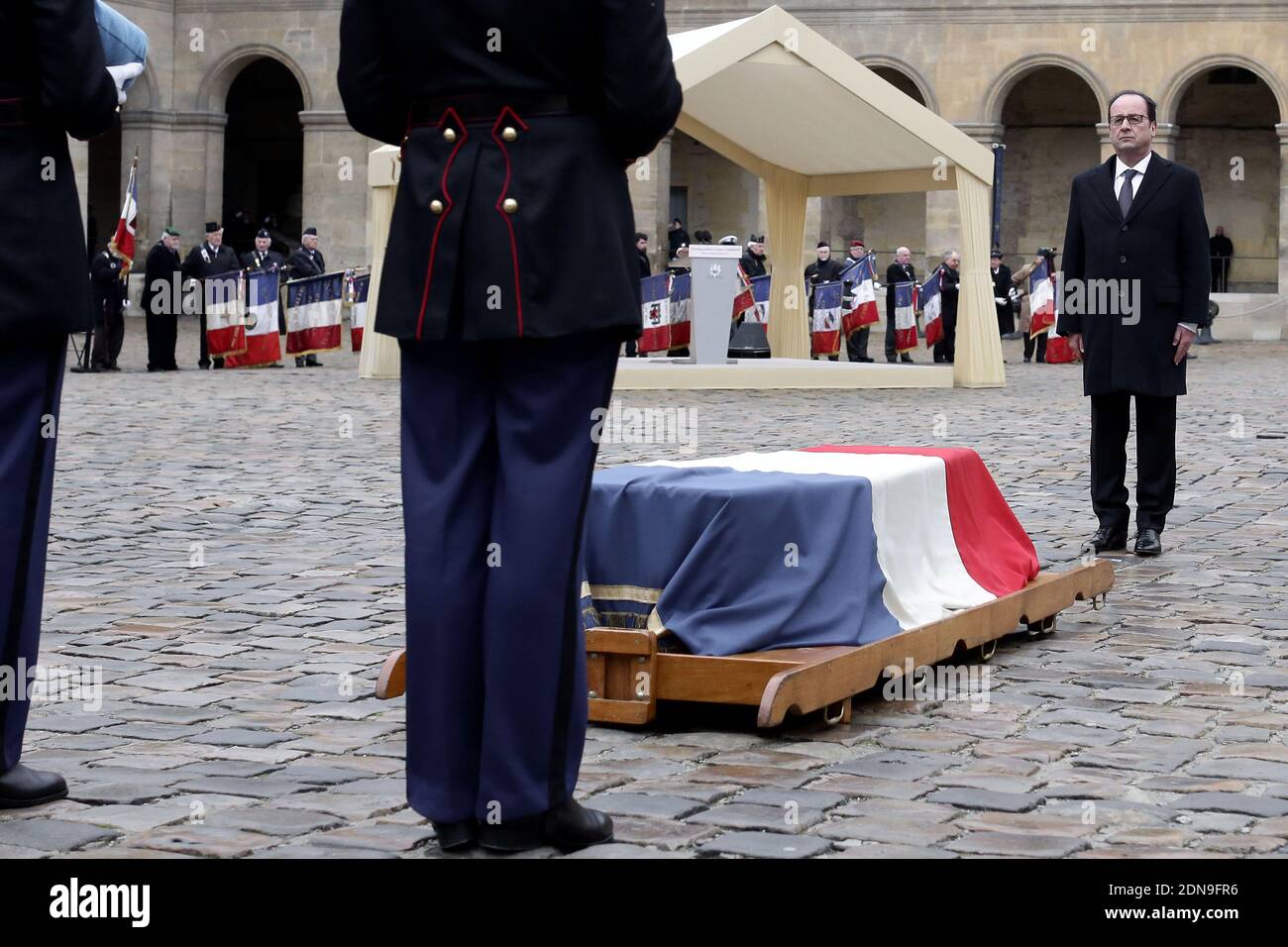 French President Francois Hollande stands to attention during a funeral ...