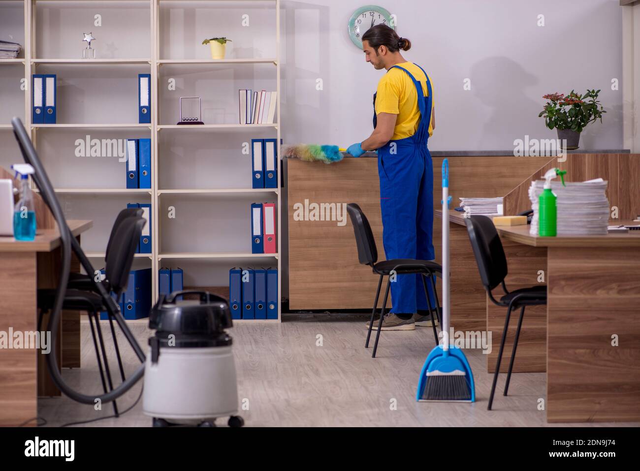 Male contractor cleaning the office Stock Photo - Alamy