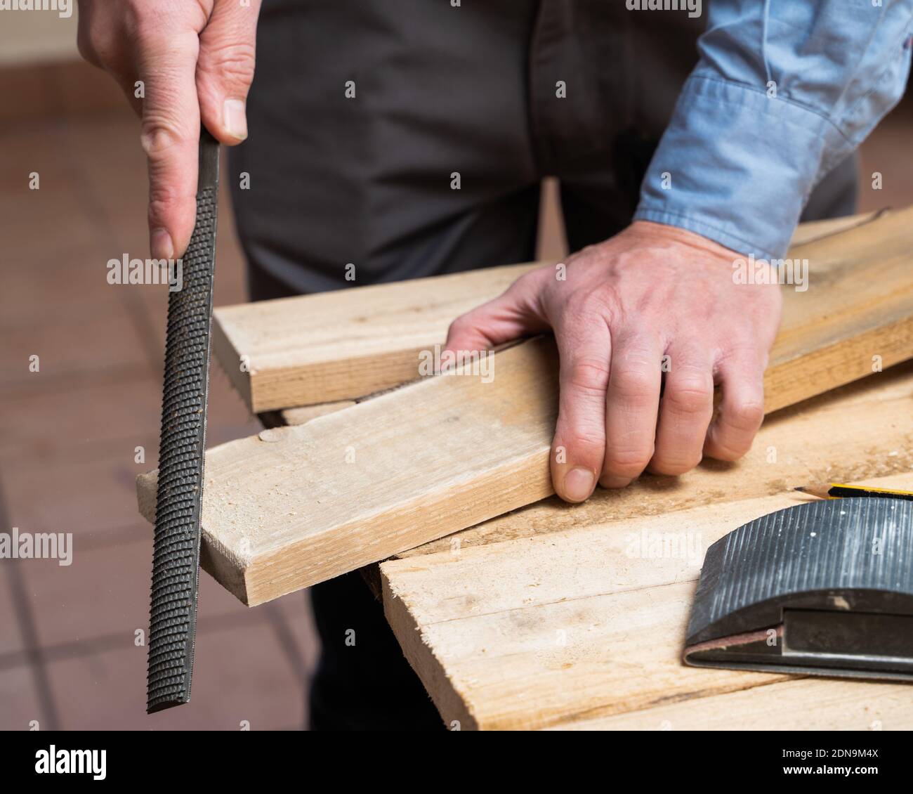 A carpenter in the process of renovating and making something from wood ...