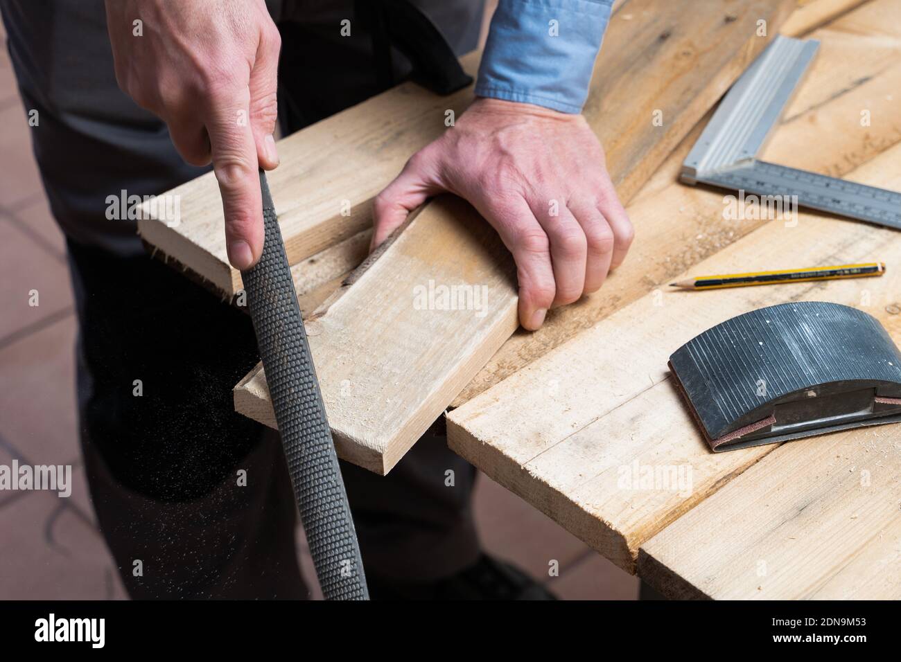 A carpenter in the process of renovating and making something from wood ...