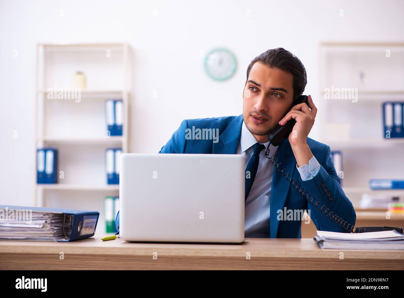 Young employee and too many work in the office Stock Photo - Alamy