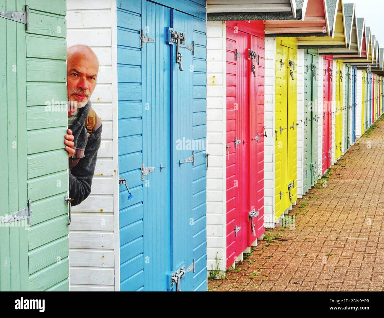 Man hiding behind door hi-res stock photography and images - Alamy