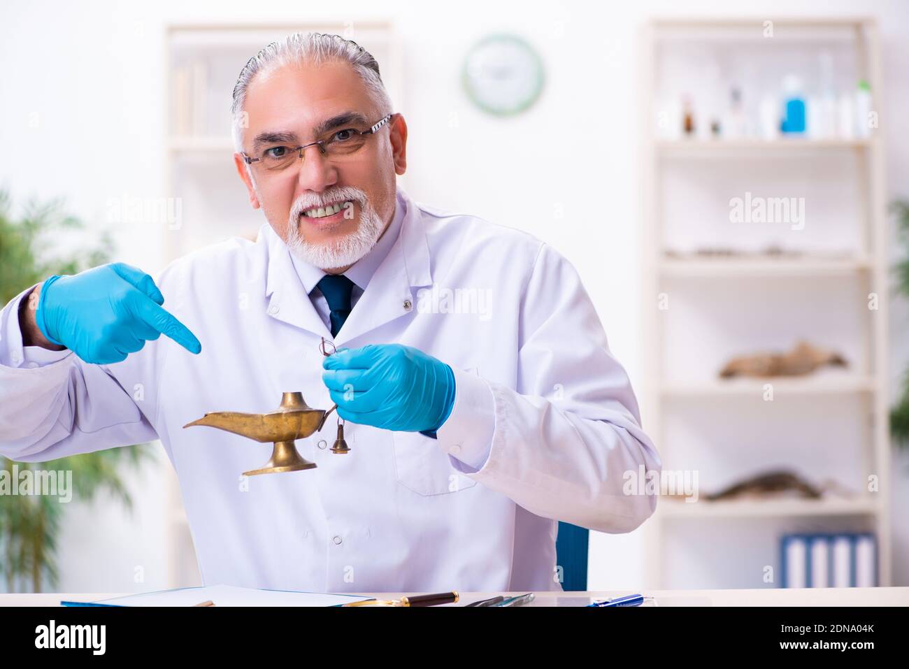 Old male archaeologist working in the lab Stock Photo - Alamy