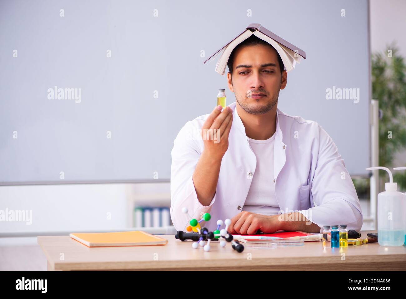 Young chemistry teacher in the classroom Stock Photo - Alamy