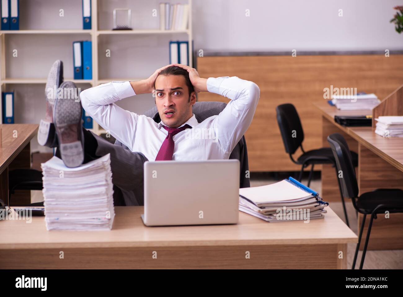 Young employee extremely tired with excessive work Stock Photo - Alamy
