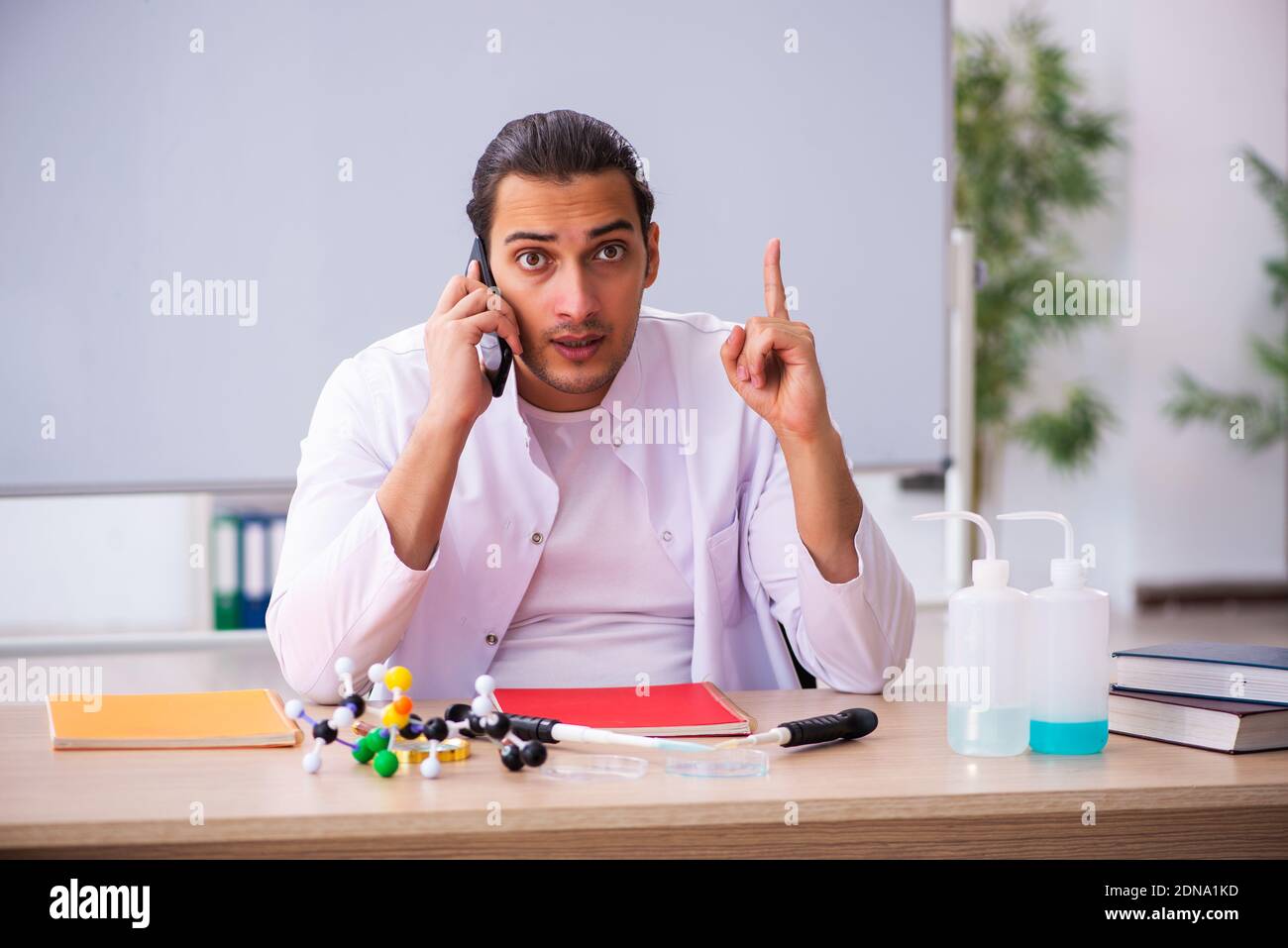 Young chemistry teacher in the classroom Stock Photo - Alamy