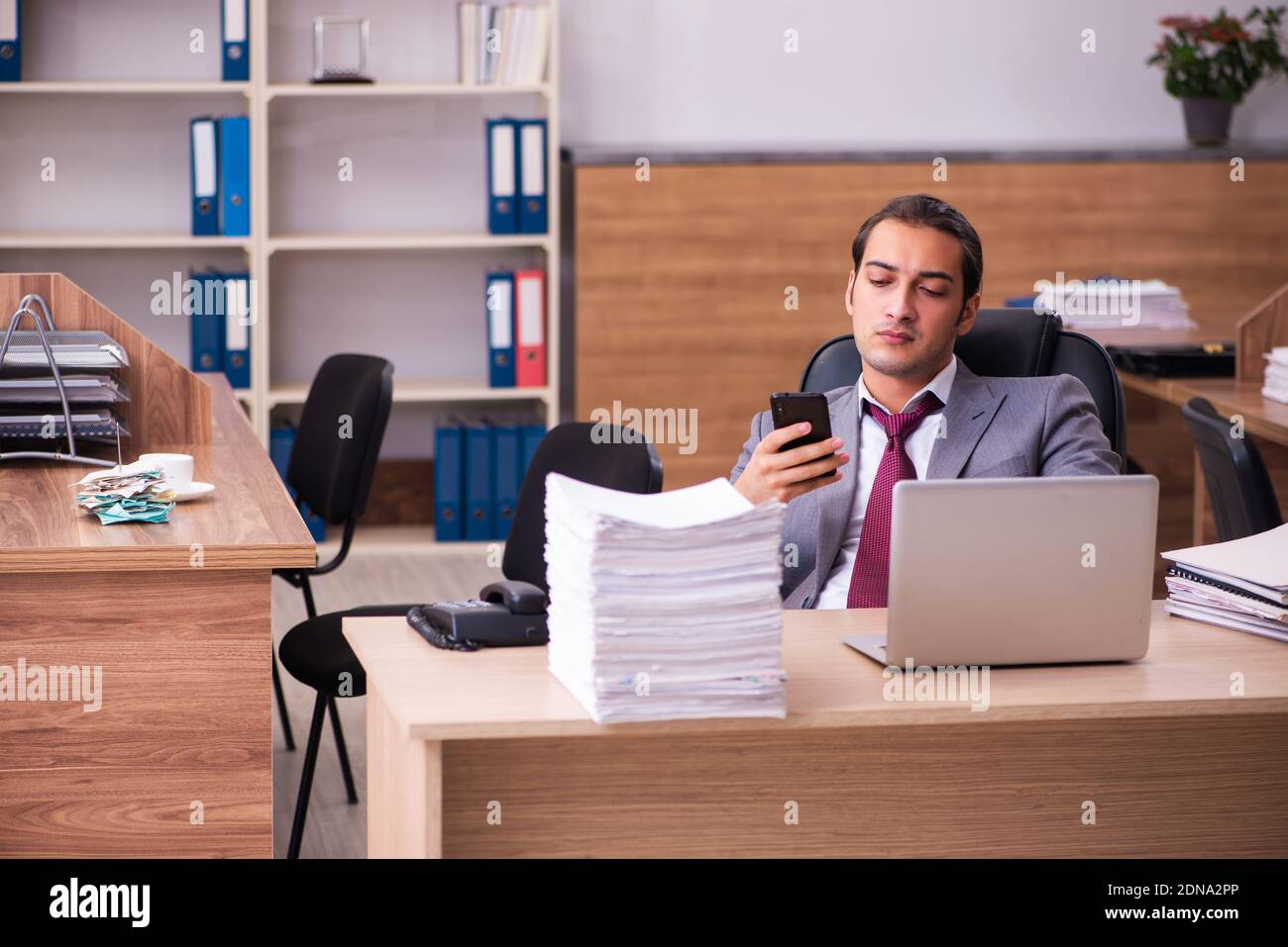 Young employee extremely tired with excessive work Stock Photo - Alamy