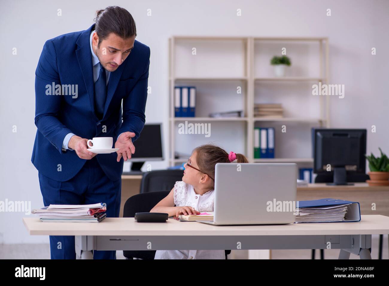 Father secretary and daughter boss in funny concept Stock Photo - Alamy
