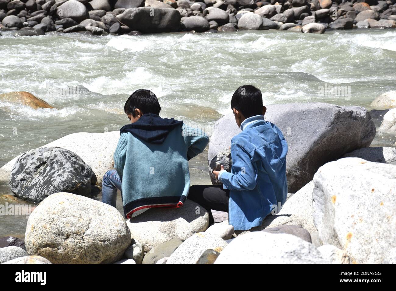 Boys Sitting On Rock River High Resolution Stock Photography and Images ...