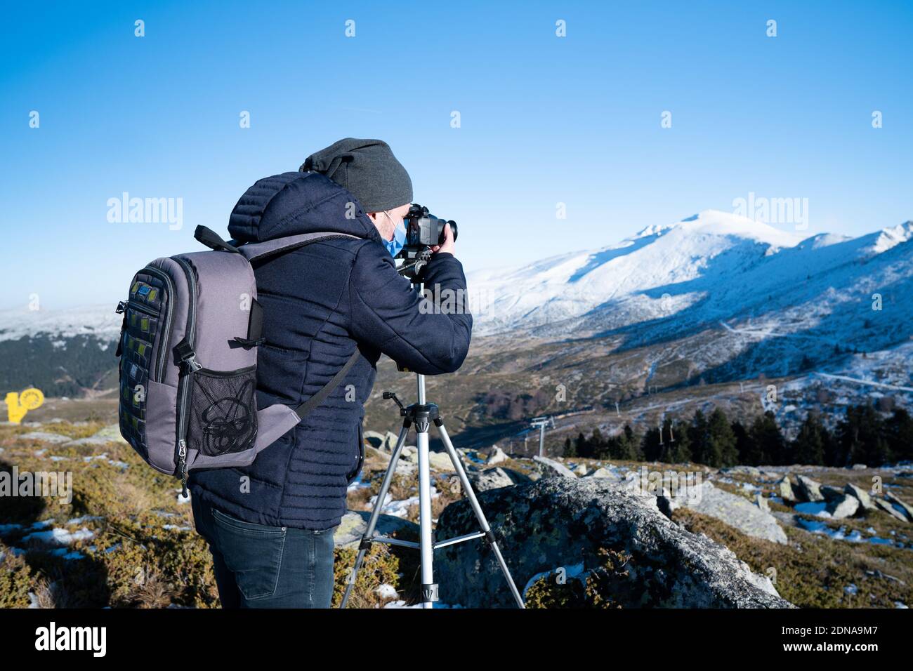 Man in the mountain photographing the mountain covered with snow Stock ...