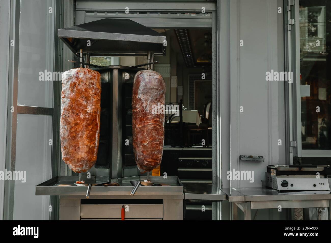 Traditional Turkish food. Doner Kebab on rotating vertical spits near ...