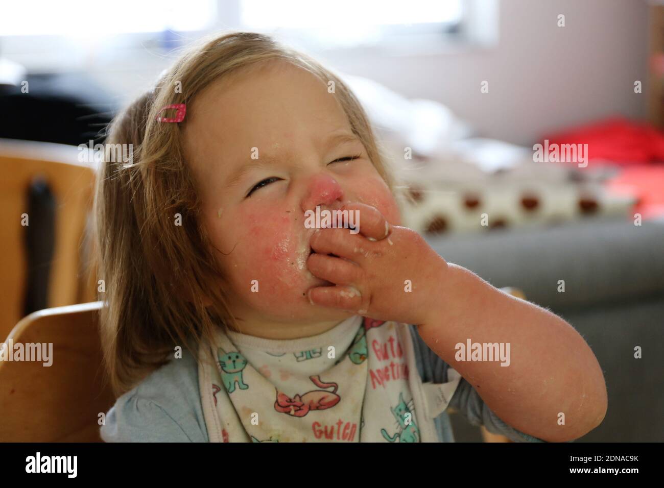Cute Girl Eating Food At Home Stock Photo - Alamy