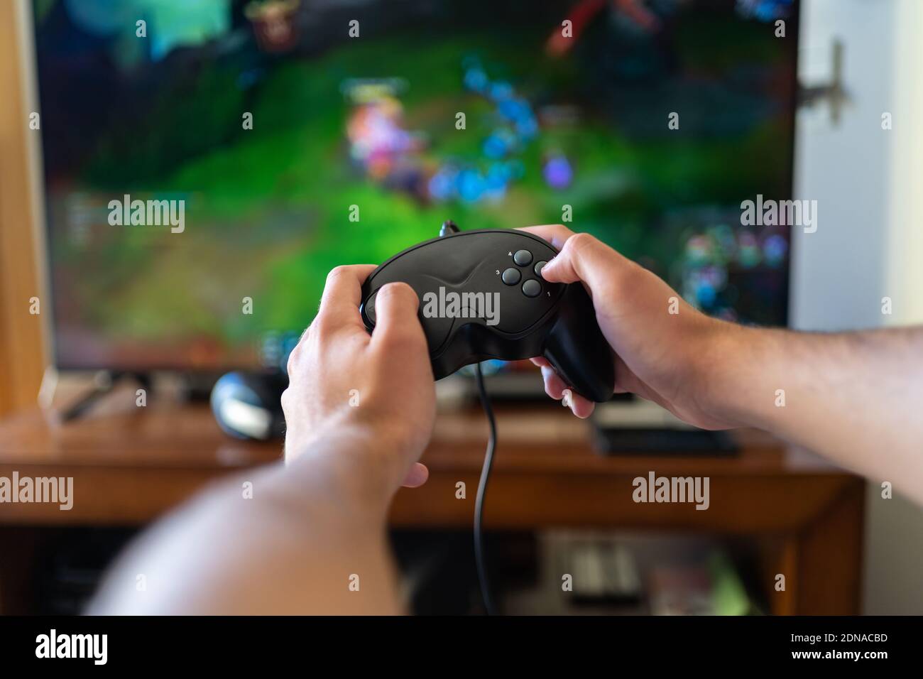 Hands with controller on it playing video games on TV Stock Photo - Alamy