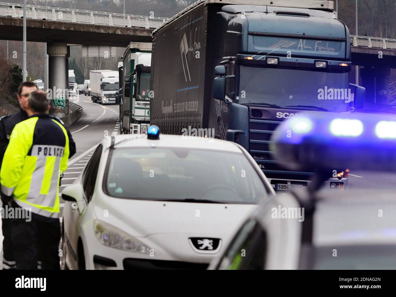 Truck drivers carry out a go-slow operation early on January 22, 2015 ...