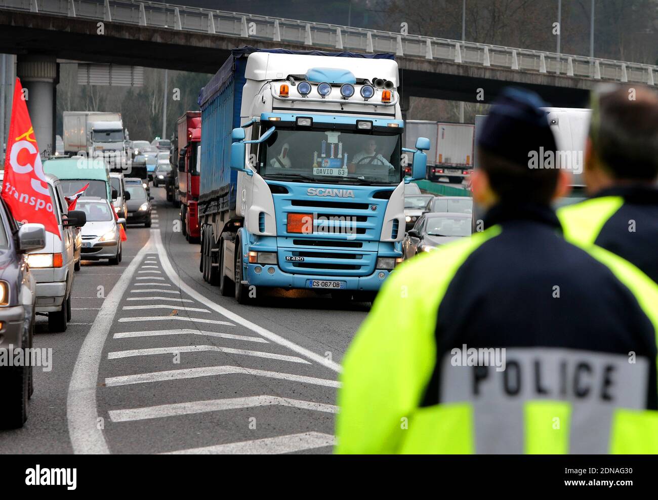 Truck drivers carry out a go-slow operation early on January 22, 2015 ...