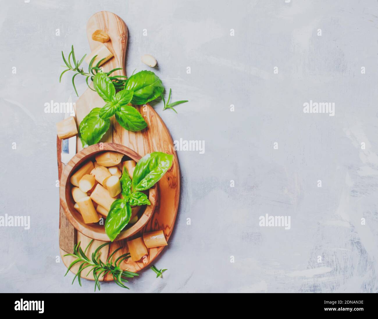 Traditional smoked Chechil cheese in bowl and cutting board, top view ...