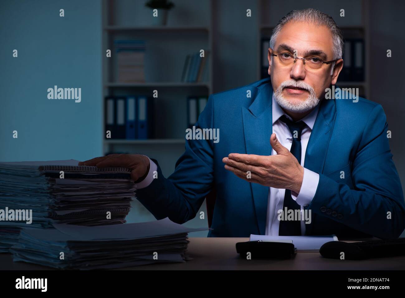 Old employee working late in the office Stock Photo - Alamy