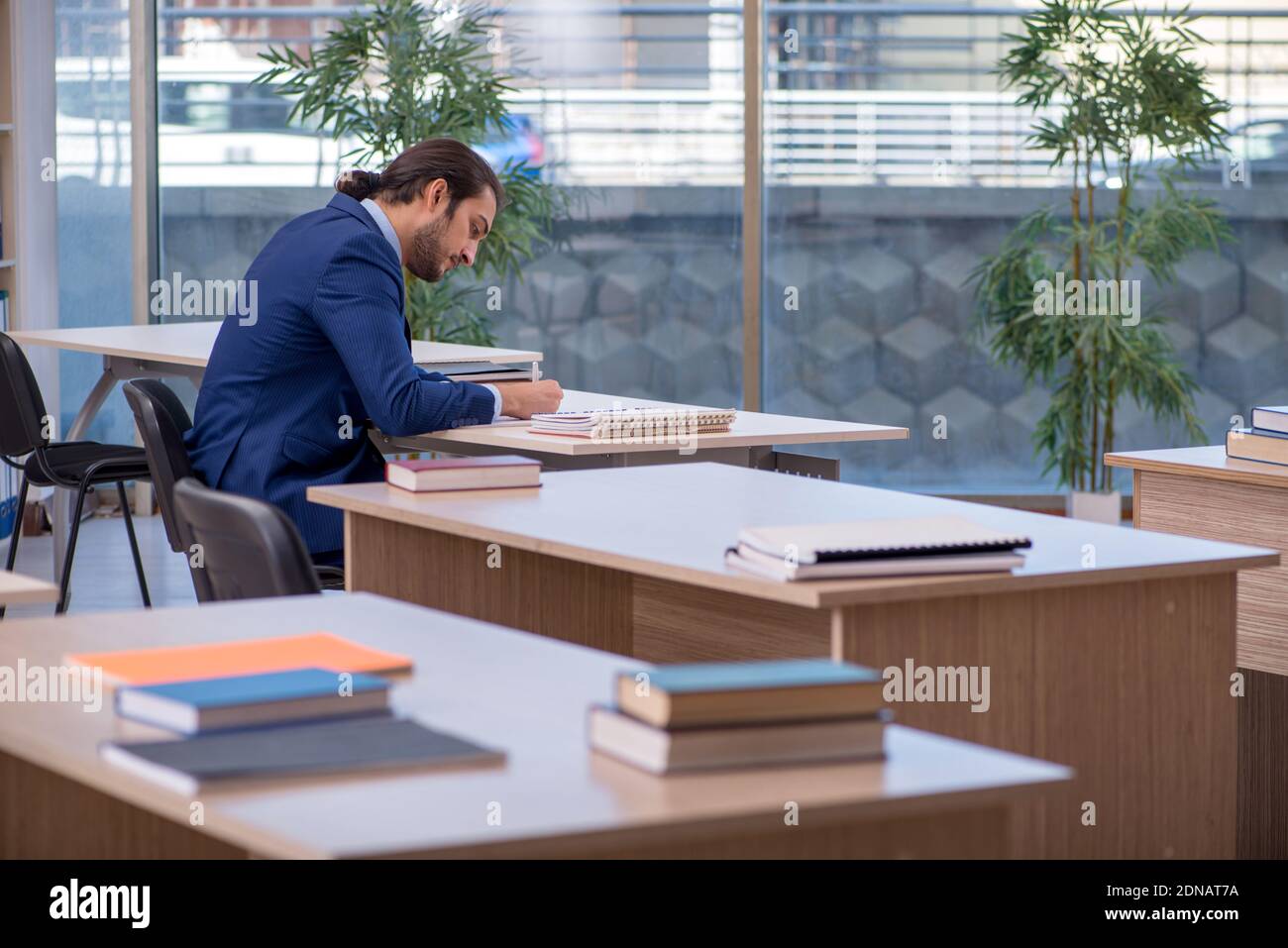 Young teacher in suit in the classroom Stock Photo - Alamy