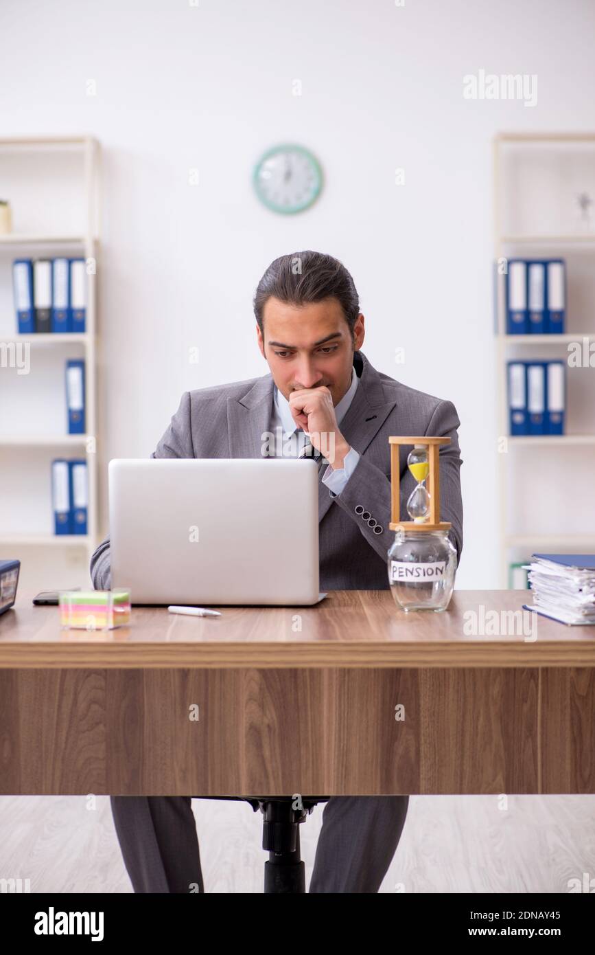 Young employee in pension concept at workplace Stock Photo - Alamy