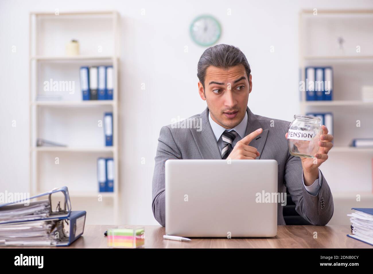 Young employee in pension concept at workplace Stock Photo - Alamy