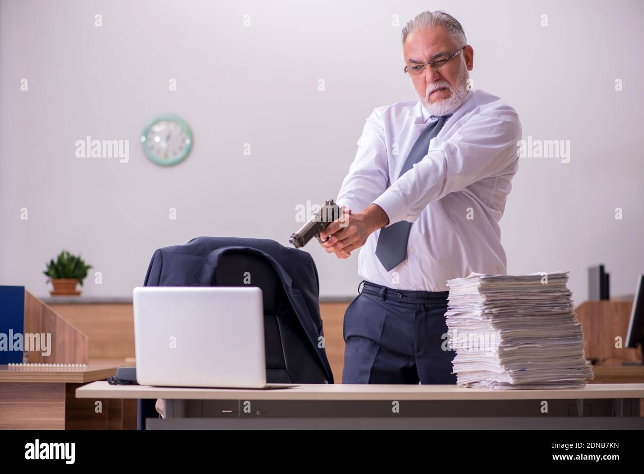 Old employee being desperate with excessive work in the office Stock ...