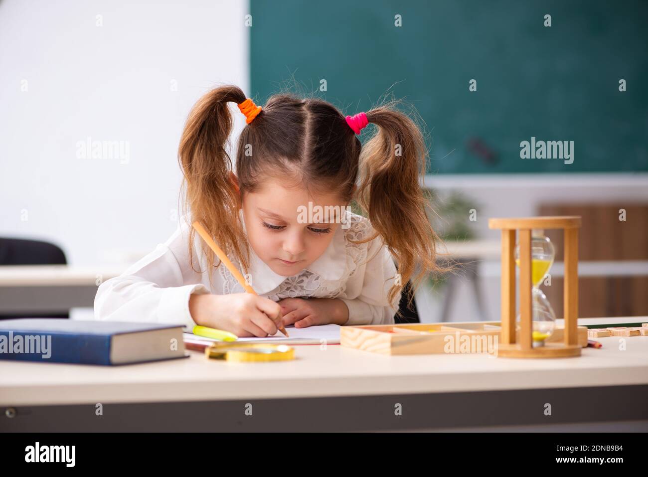 Small girl in the time management concept Stock Photo - Alamy