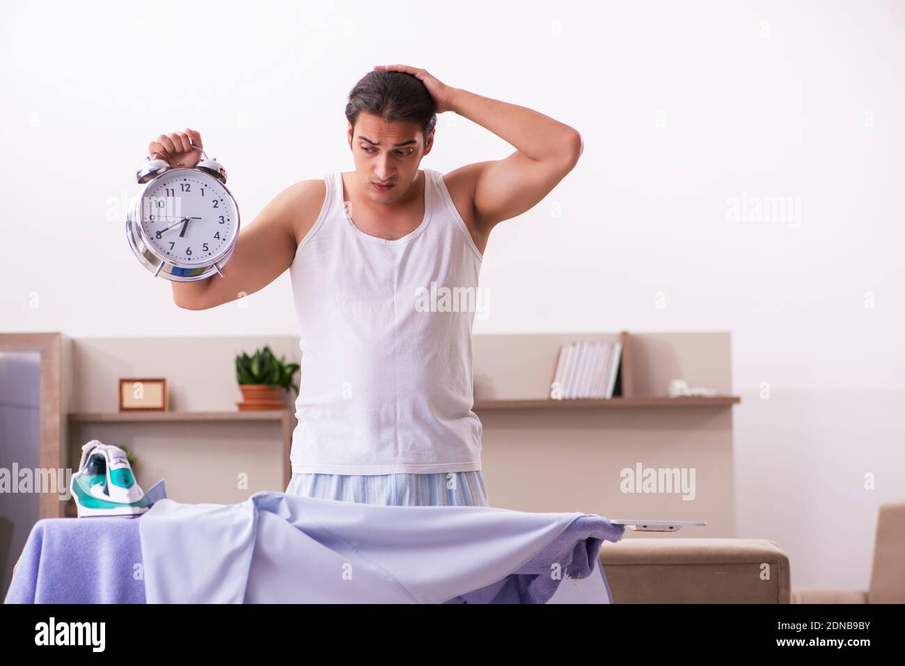 Young employee getting up late at home Stock Photo - Alamy