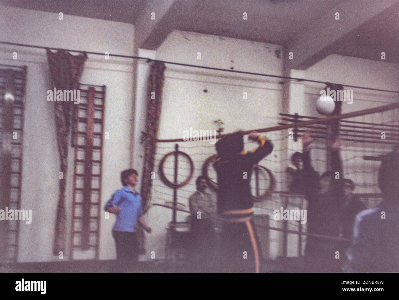 MILAN, ITALY 18 AUGUST 1975: Kids play volleyball in the school gym ...