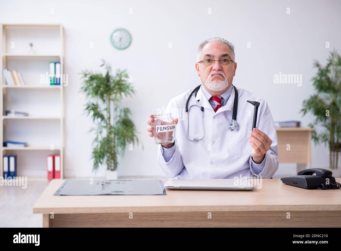 Old doctor in retirement concept Stock Photo - Alamy