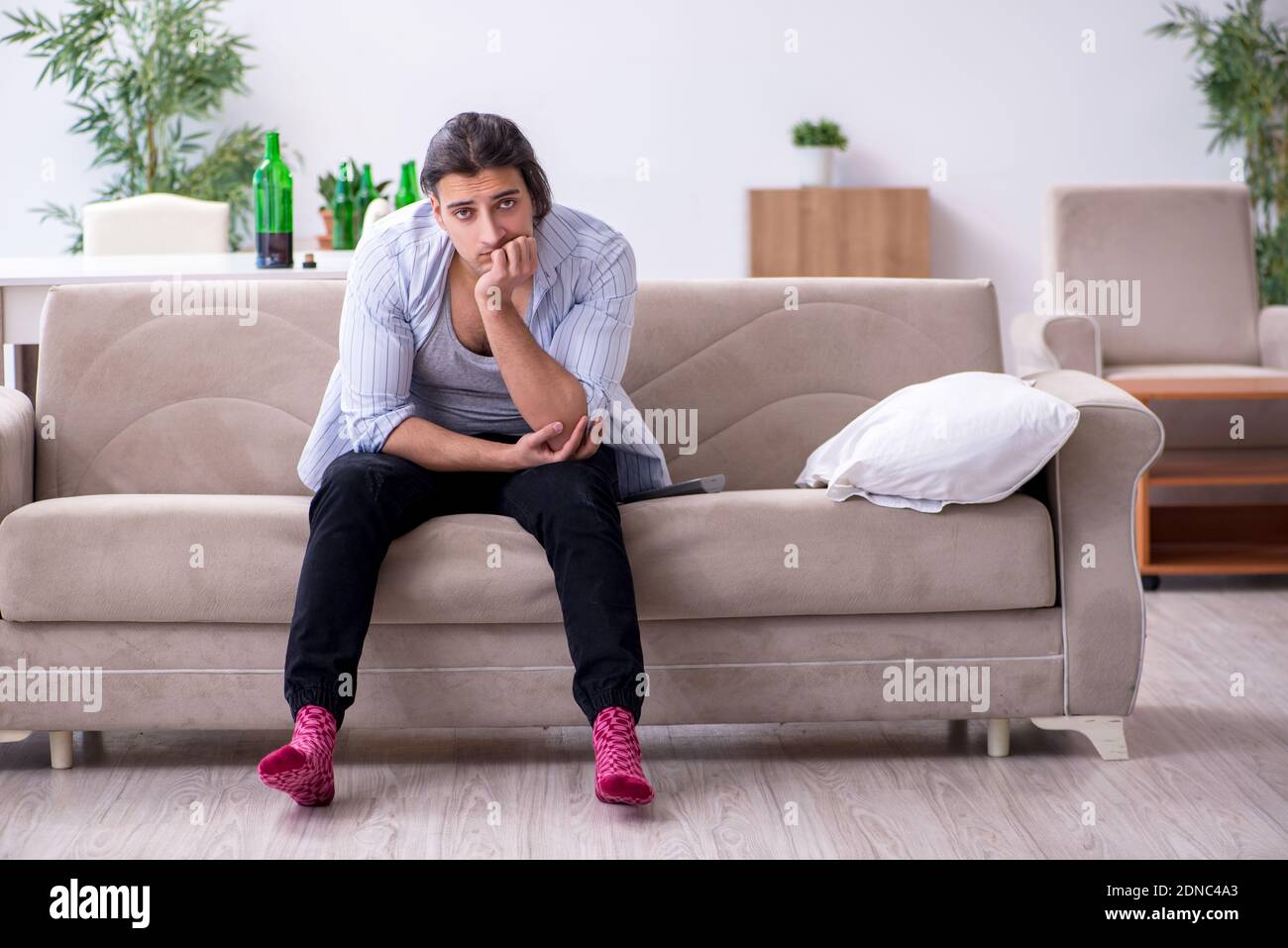 Male alcoholic drinking wine at home Stock Photo - Alamy