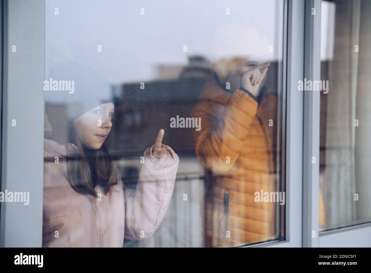 Sad children stand by the window and miss a normal life. They want to ...