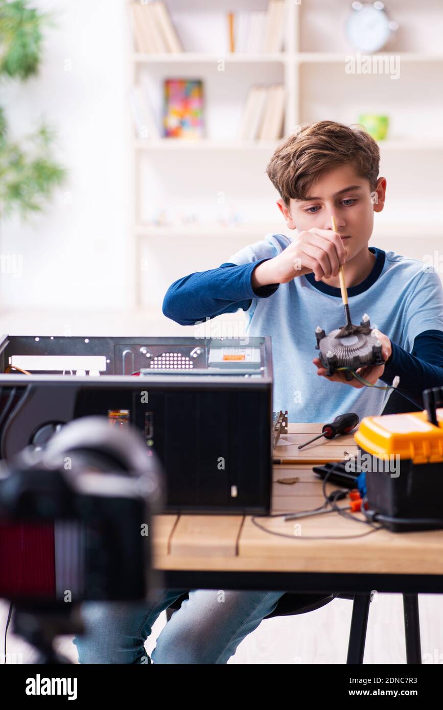 Teenager computer repairman recording video for his blog Stock Photo ...