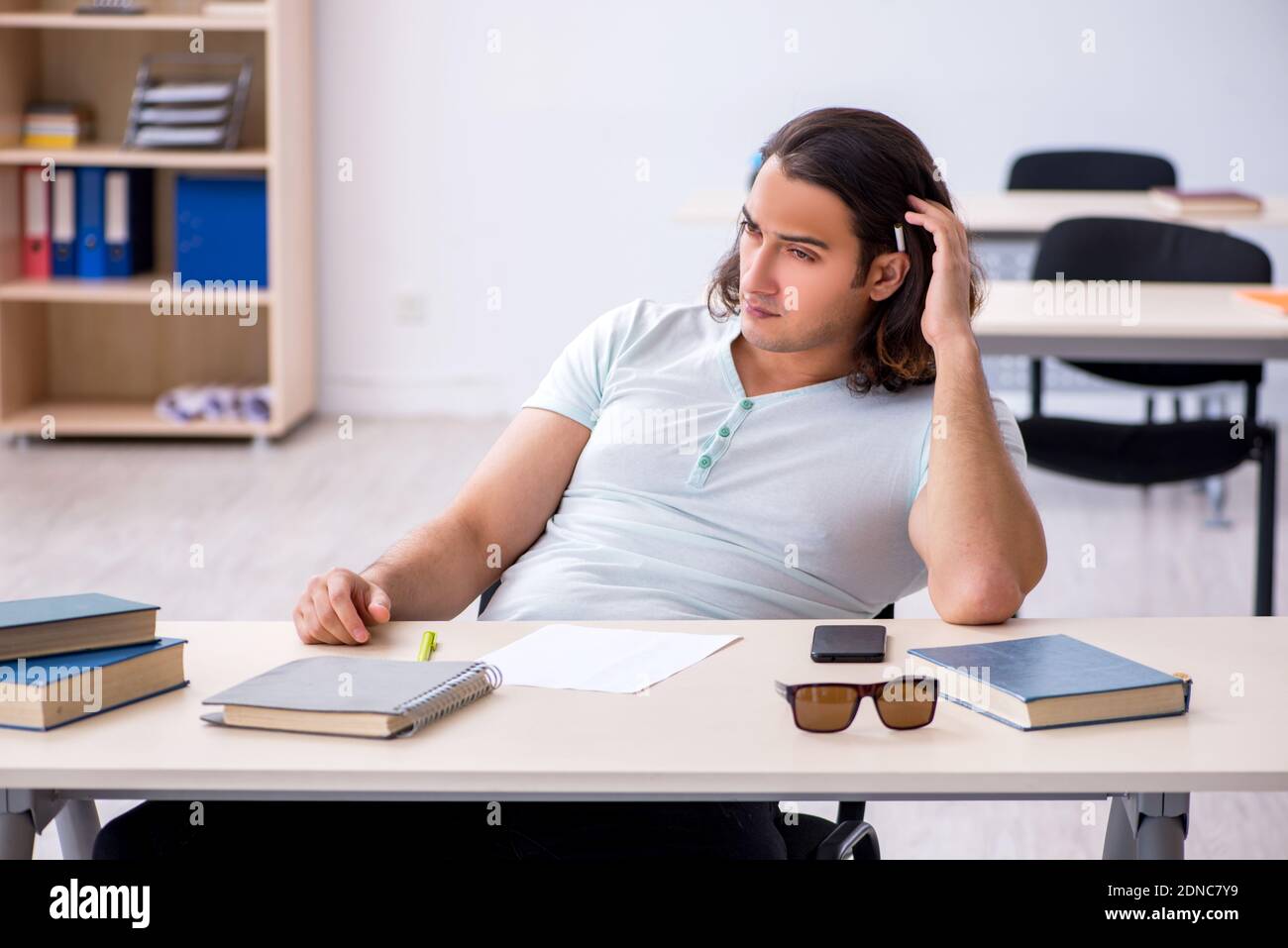Young student preparing for exam in the classroom Stock Photo - Alamy