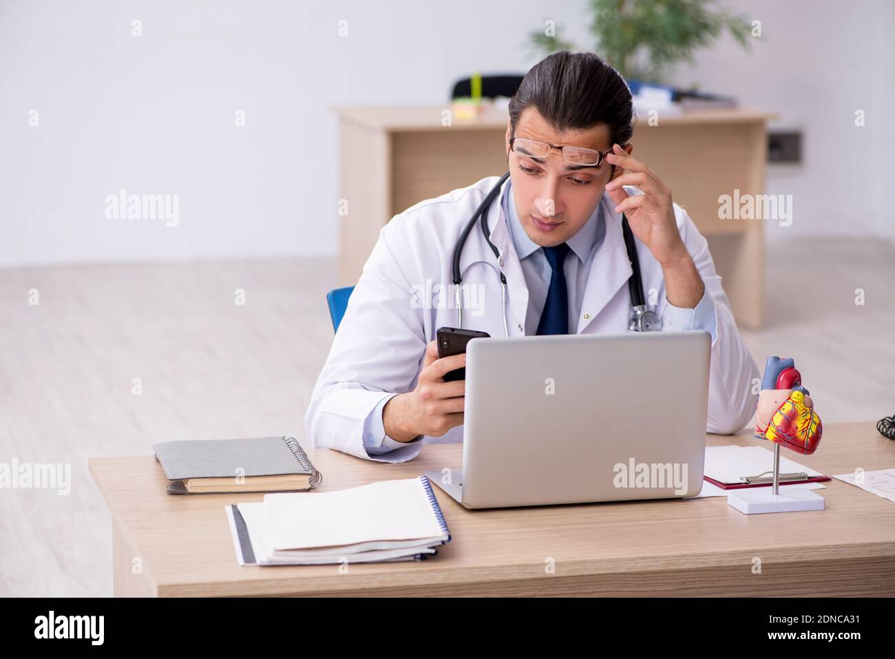 Young doctor cardiologist working in the clinic Stock Photo - Alamy