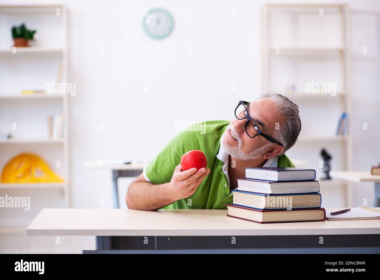 Male teacher eating apple hi-res stock photography and images - Alamy
