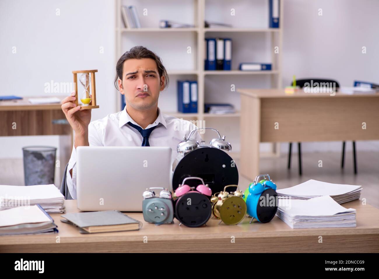 Young employee afraid of missing deadline at workplace Stock Photo - Alamy