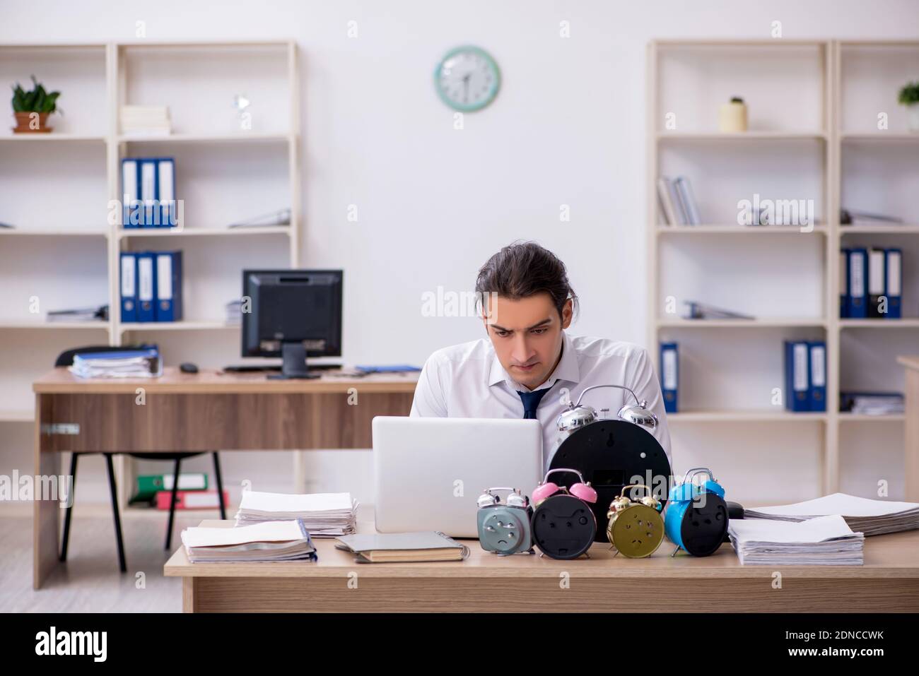Young employee afraid of missing deadline at workplace Stock Photo - Alamy