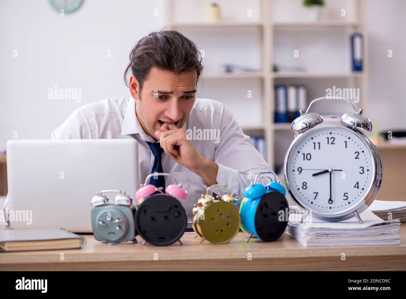 Young employee afraid of missing deadline at workplace Stock Photo - Alamy