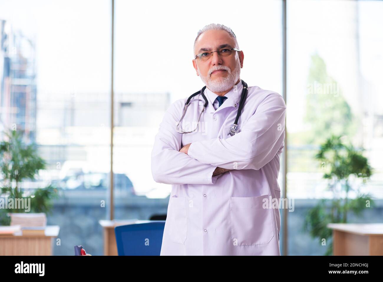 Old doctor working in the clinic Stock Photo - Alamy