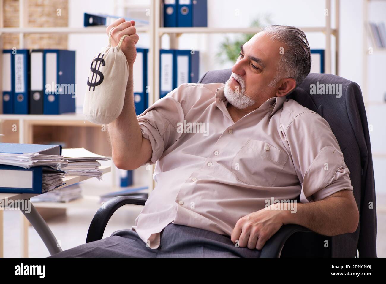 Senior male employee with moneybag in retirement concept Stock Photo ...