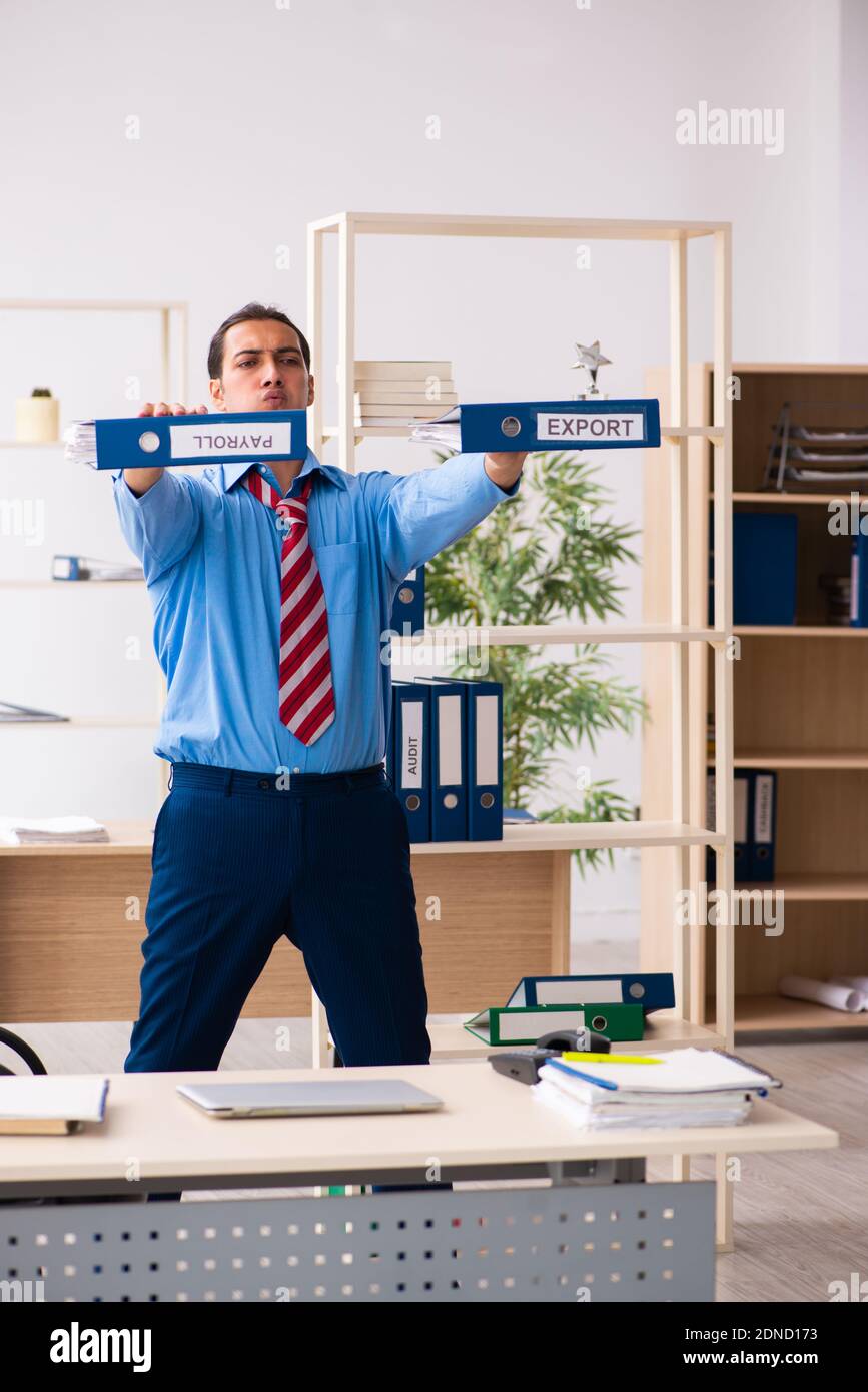 Young businessman doing sport exercises at workplace Stock Photo - Alamy