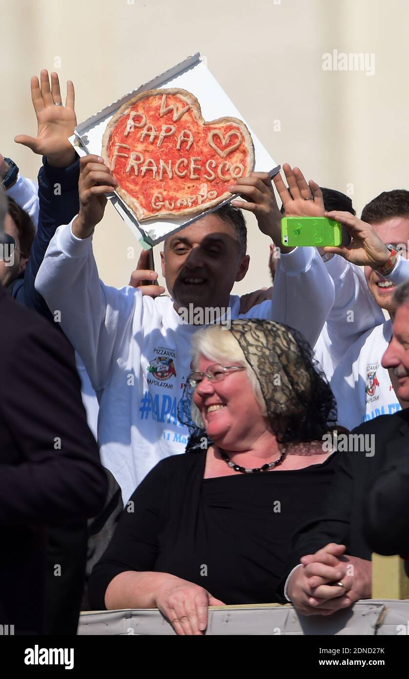 A man shows a pizza made for pope Francis during the weekly general ...