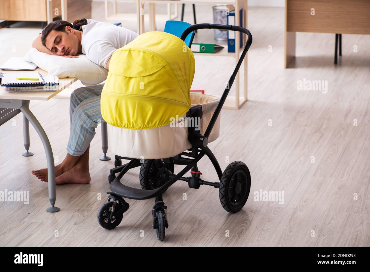 Young employee looking after newborn at workplace Stock Photo - Alamy
